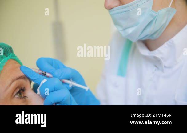 Cosmetology doctor female makes botox medicine injection to her patient ...