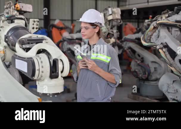 Maintenance engineer worker working with robotic machine automation at factory, Female ...