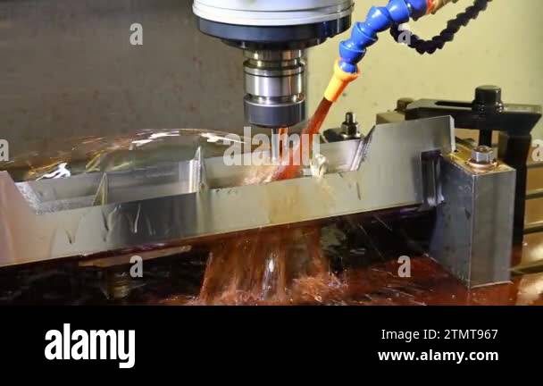 The CNC milling machine cutting the tire mold parts with oil coolant ...