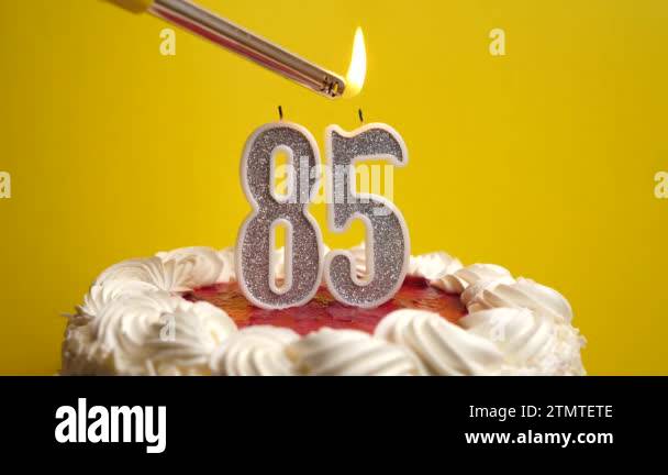 A candle in the form of the number 85, inserted into the holiday cake ...
