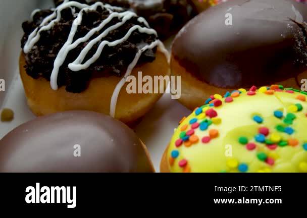 beautiful delicious fresh appetizing donuts with nuts with sprinkles ...