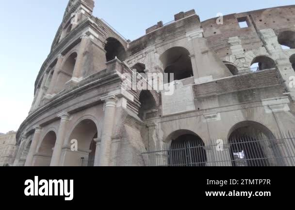 Low angle pan right on Colosseum in Rome largest amphitheater in the ...