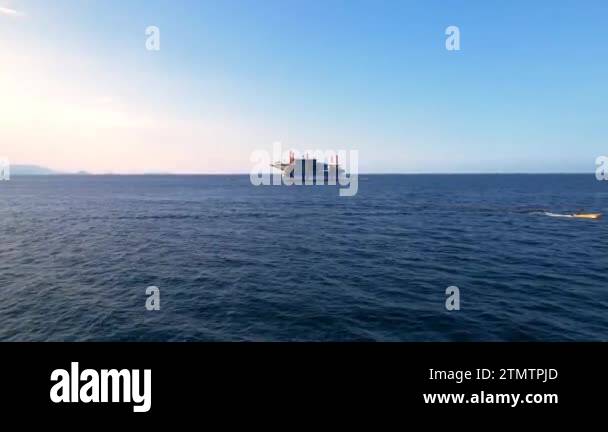 An offshore oil rig in the middle of the ocean, towering over the ...