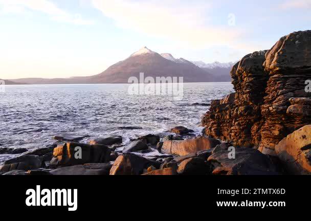 Minute before sunset at sea. Waves crashing to sharp rock of the Isle ...