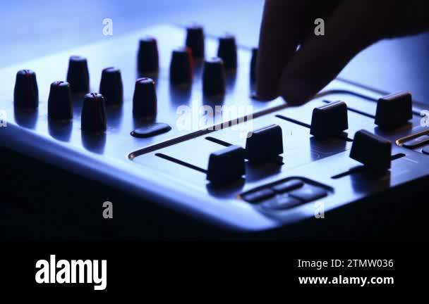 Hand adjusting professional audio mixer console with knobs and ...