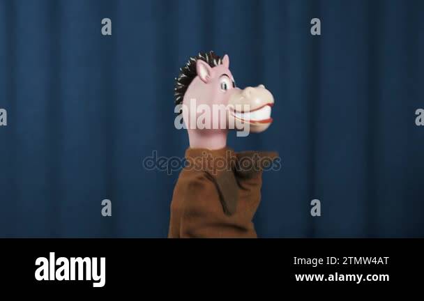 Horse hand puppet nodding head and shaking on scene with blue ...