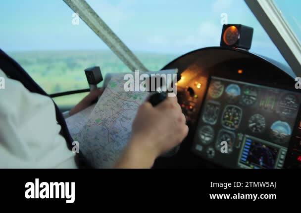 Male pilot holding steering wheel, checking route to flight destination ...
