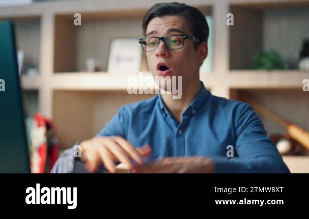 Emotional businessman talking computer videocall at office close up ...