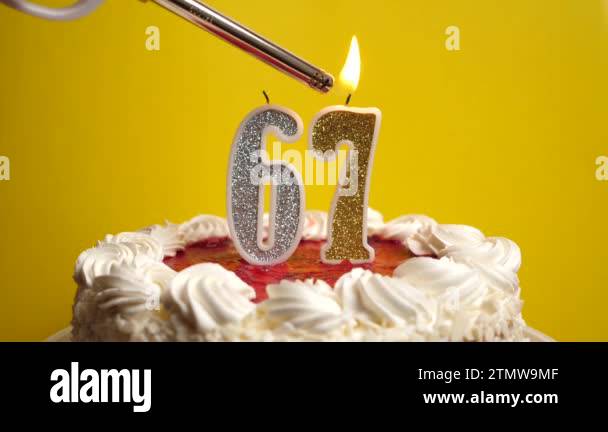 A candle in the form of the number 67, inserted into the holiday cake ...
