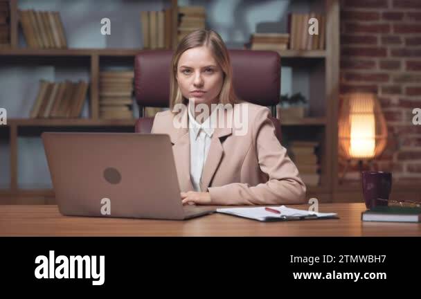 Strict company director pointing with finger at manual clock while ...