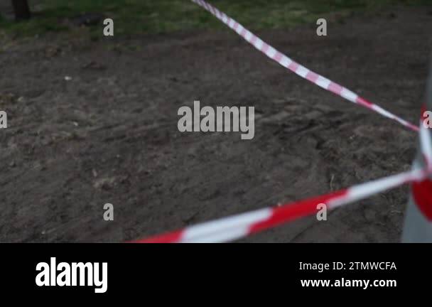 Focus on red and white barrier tape at the construction site. No entry ...