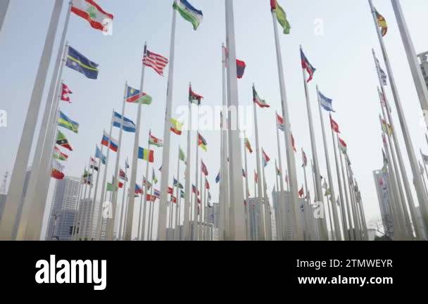 bottom view footage of flags of world waving on blue sky background ...