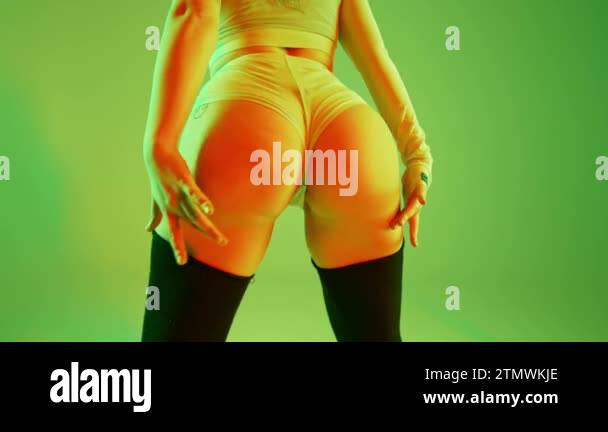 Sexy woman dancing modern dance - twerk. Girl shaking, twerking her buttocks on studio ...
