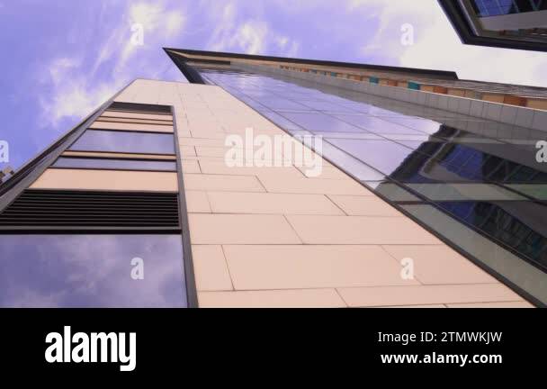 Narrow passage between modern residential buildings. Walls of high-rise ...