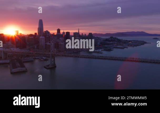 Aerial sliding shoot of San Francisco City at golden hour with rose ...