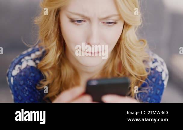 Very upset young woman reading a message on your mobile phone, crying ...