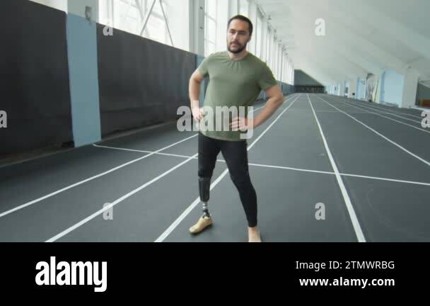 Professional male athlete with prosthetic leg doing hip rotation ...