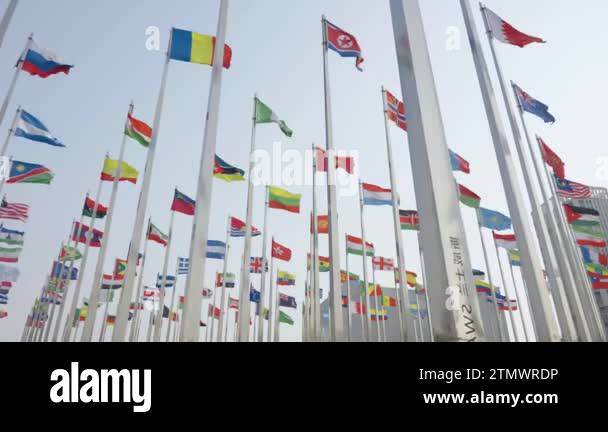 bottom view footage of flags of world waving on blue sky background ...