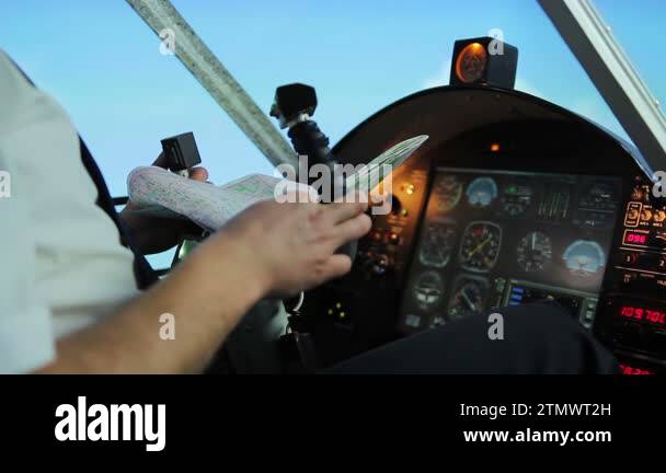 Pilot navigating aircraft with steering wheel, checking flight route on ...