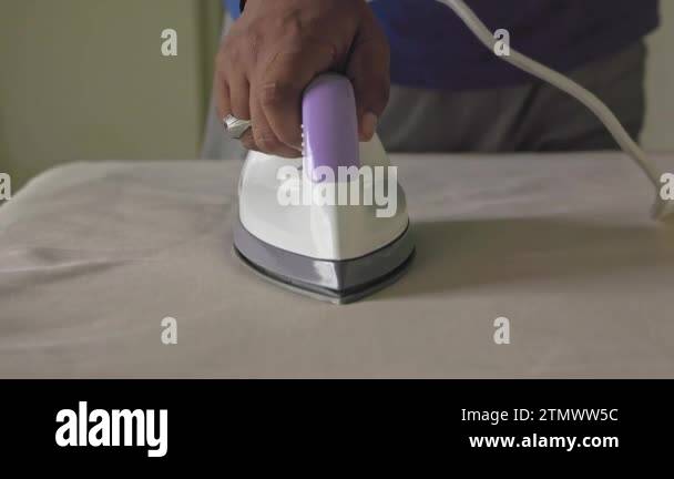 Man ironing clothes on an ironing board.hand with iron housework.male ...