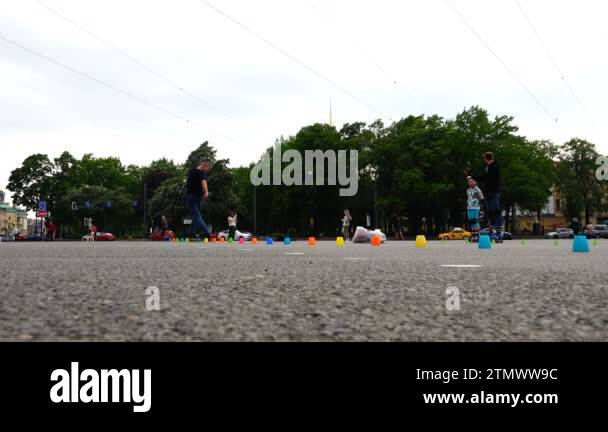 athletes on roller skates and uniforms ride on the pavement with ...