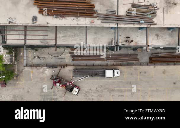 Observe how building strength is heightened as workers load metal beams ...