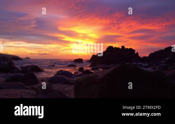 stunning sunset above the rock at Kalim beach Patong Phuket. .Scene of ...