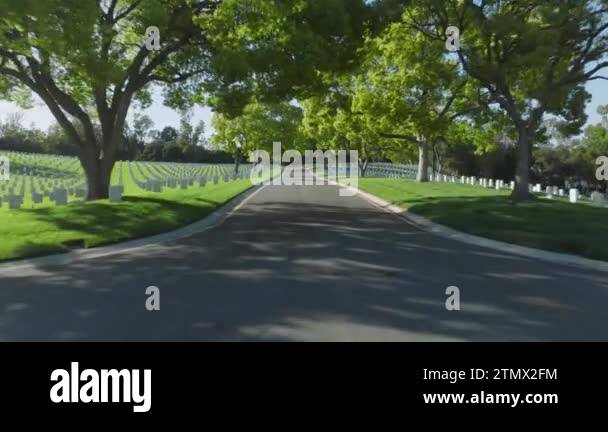 Drone flying fast along the road in cemetery park in California, United ...