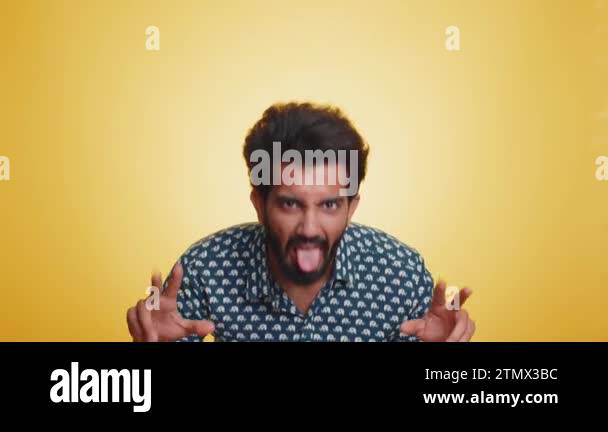 Comical funny young indian man making playful silly facial expressions ...