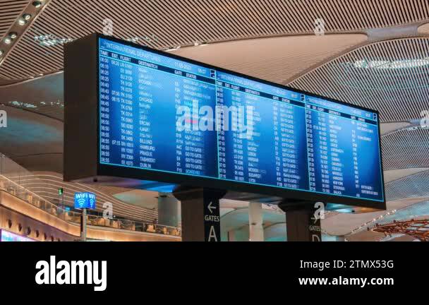 Time lapse. People in international airport looking at the flight ...