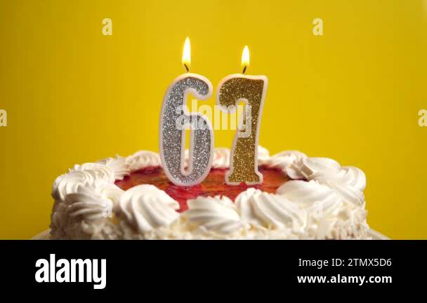 A candle in the form of the number 67, inserted into the holiday cake ...