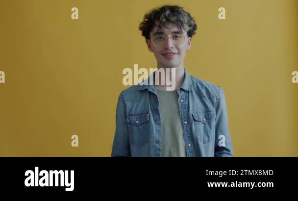 Portrait of joyful student raising Yes sign and showing thumbs-up hand ...