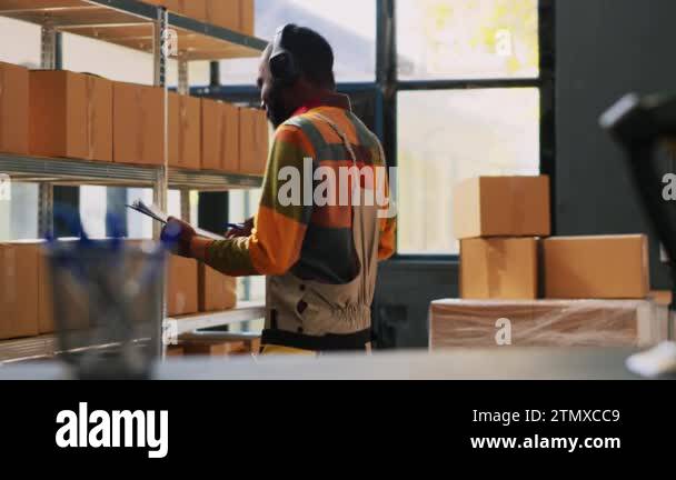 Supervisor inspecting stock logistics with inventory list, looking at ...