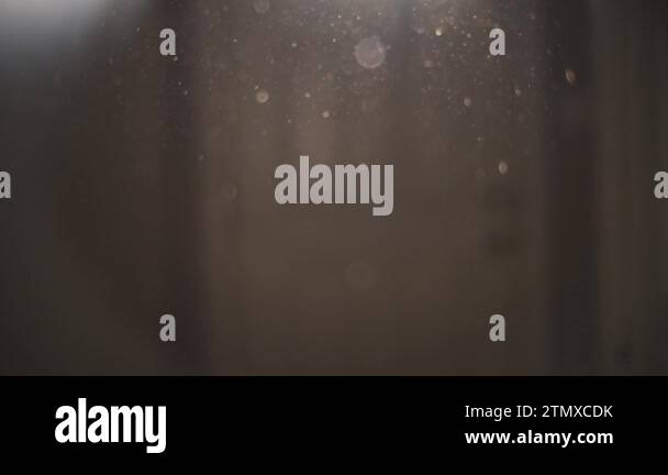 Dusty particles floating in the morning sunlight rays that create lens ...