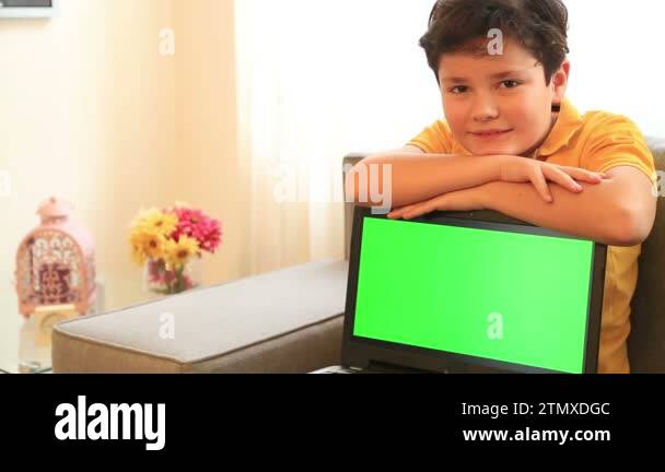 Young boy with green screen laptop monitor Stock Video Footage - Alamy