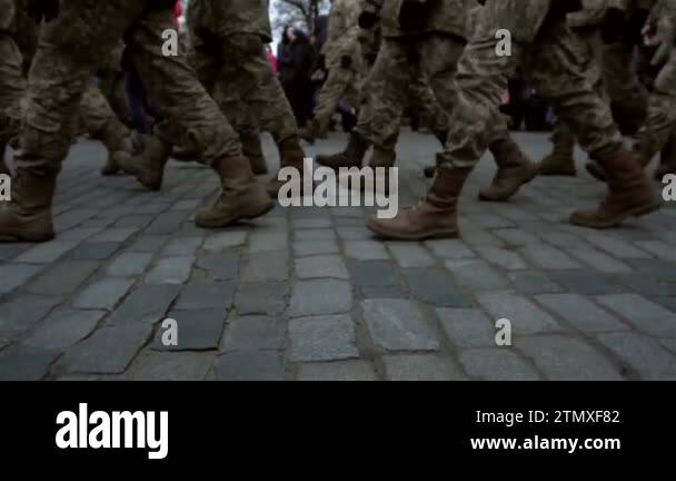 background with formation of soldiers in uniform marching on the ...