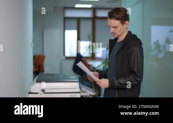 Side view portrait of troubled unsure young man with paperwork at ...