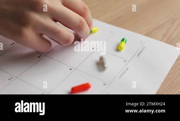 Patient puts capsules and makes routine of taking prescribed vitamins ...