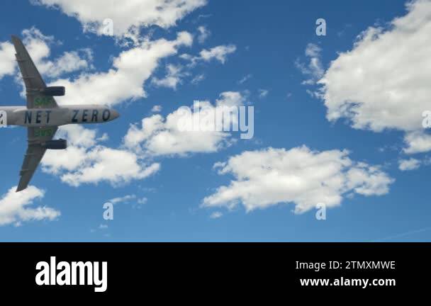 Aircraft soars through the sky with a prominent SAF and Fly Net Zero ...