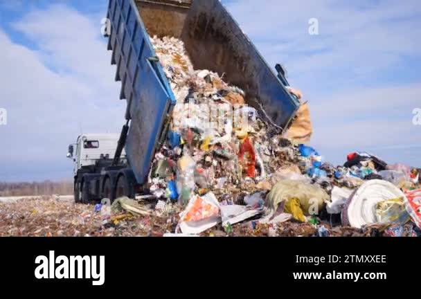Garbage truck disposed trash on the landfill. Vehicle transporting ...