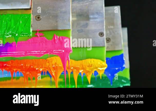 Colorful plastisol ink sticks are stretched on the printer handle ...