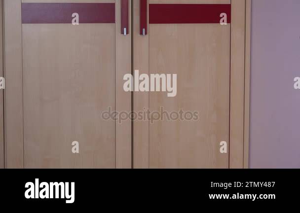 Pretty girls hiding in clothes closet. Mother and daughter open closet ...