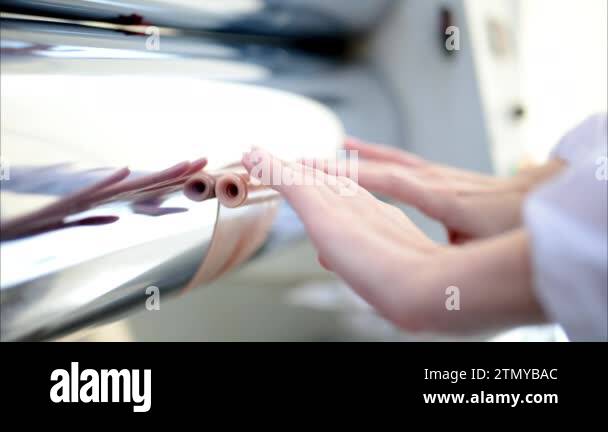 Technician making prosthetic device using grinder to smooth socket ...