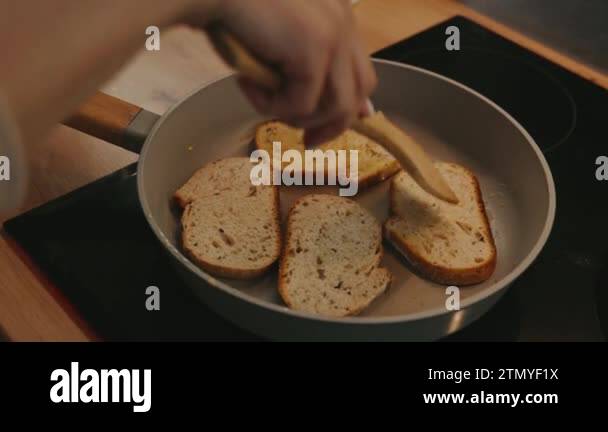Top view of frying bread toasts in the pan, the process of cooking fast ...