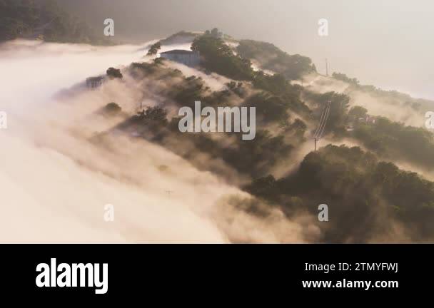 Sunrise above misty forest on mountain peak. Marvelous view drone ...