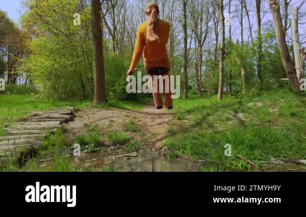 Girl sits on zipline, right over camera. Nine years old Caucasian child ...