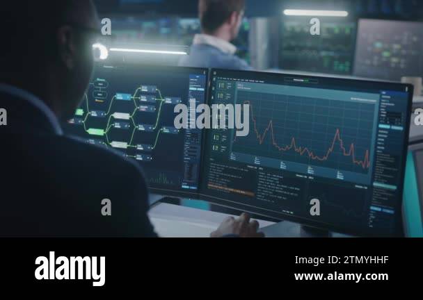 Multiracial team of IT software engineers work in monitoring office. Data server, blockchain ...