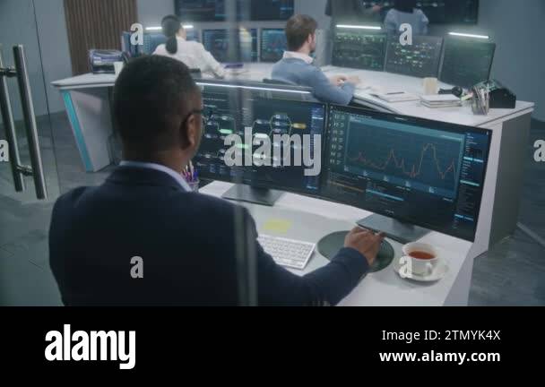 African American big data scientist works at computer in monitoring ...