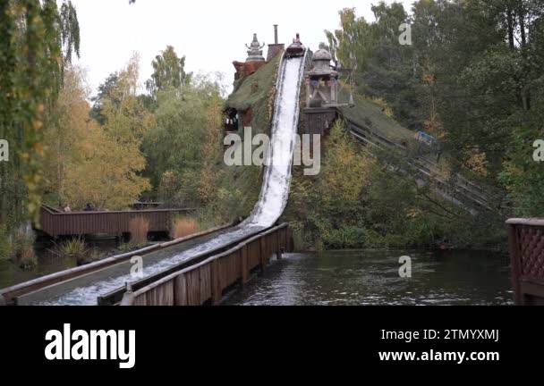 Crush down in water from water roller coaster in amusement park ...