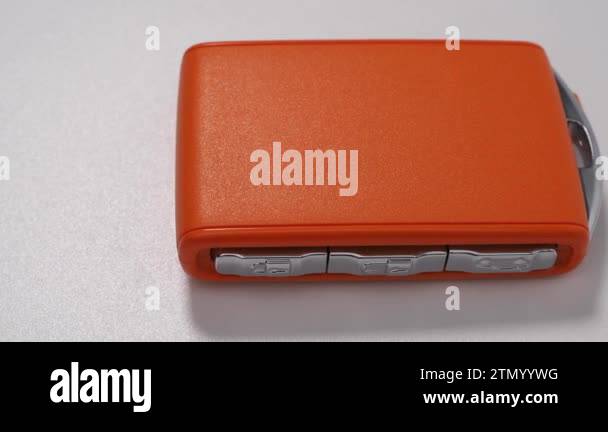 Modern wireless orange car ignition key on a white background. Wireless ...